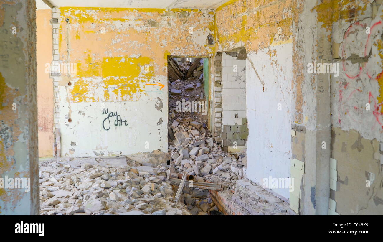 Stone rubbles on the floor inside the house that was damaged from the ...