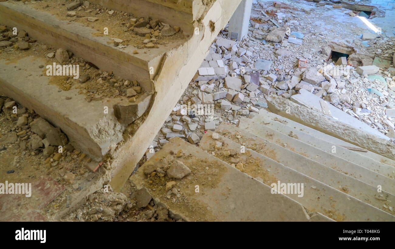 Closer look of the rubbles and stones on the stairs of a damaged house ...