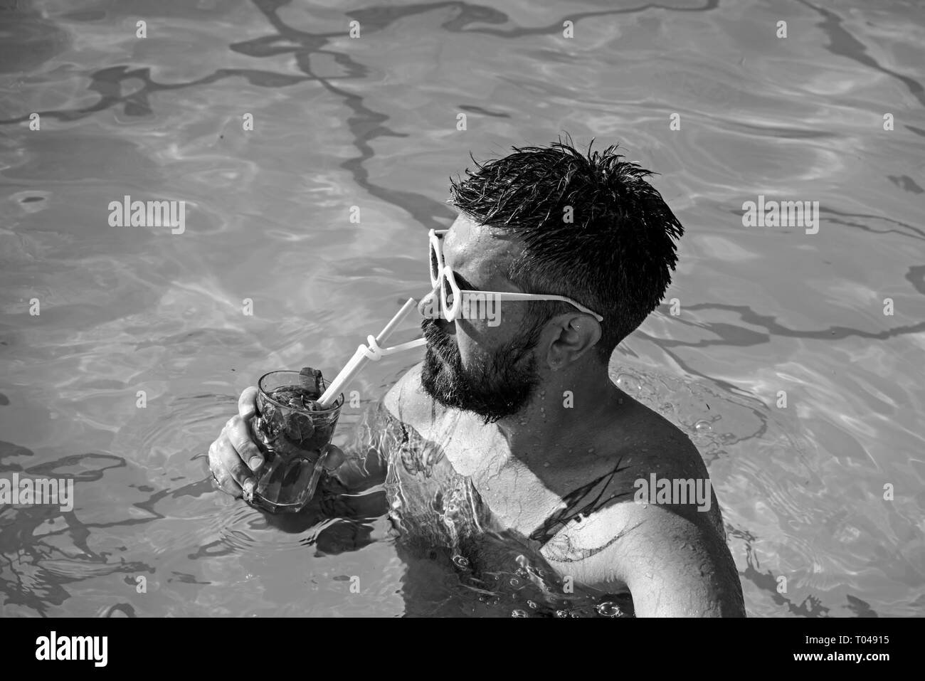 Pool party with hipster in blue water. Cocktail party with bearded man ...