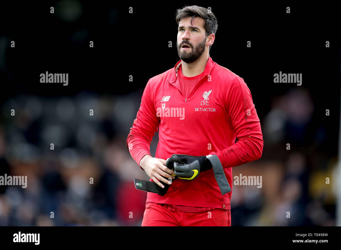 Liverpool goalkeeper Alisson Becker warms up on the pitch ahead of the ...
