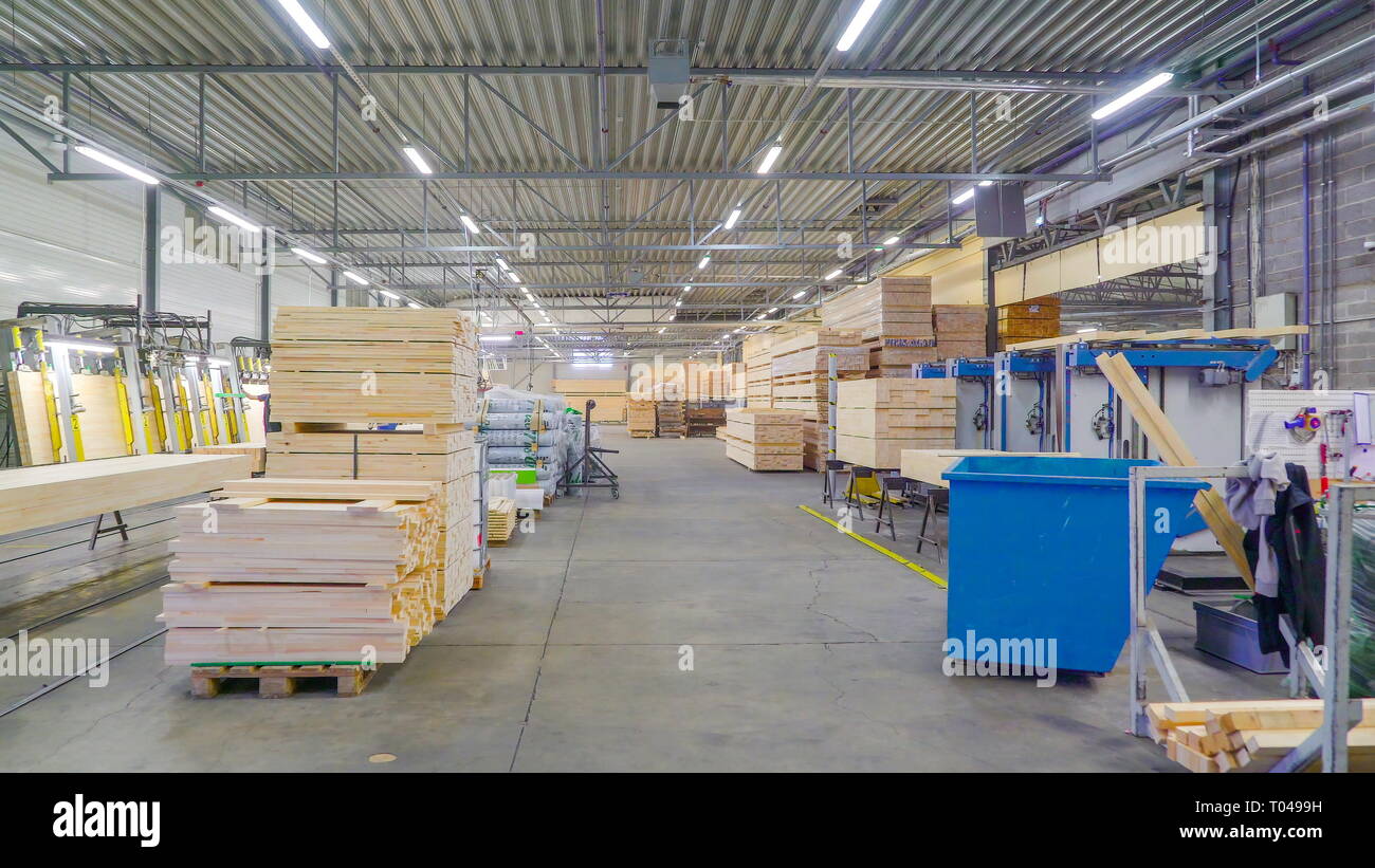 Inside look of the factory of sawmill where piles of lumbers are ...