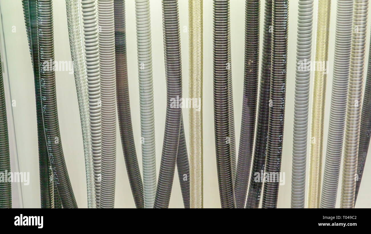 The slinky metal wires hanging on the wall being displayed in a booth ...