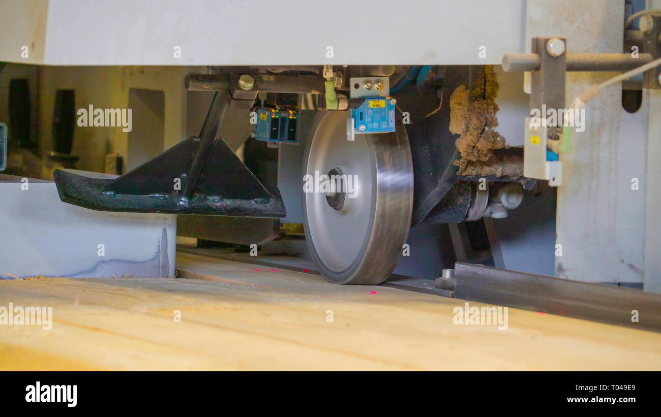 Closer look of the rolling machine smoothening the lumbers to be ...