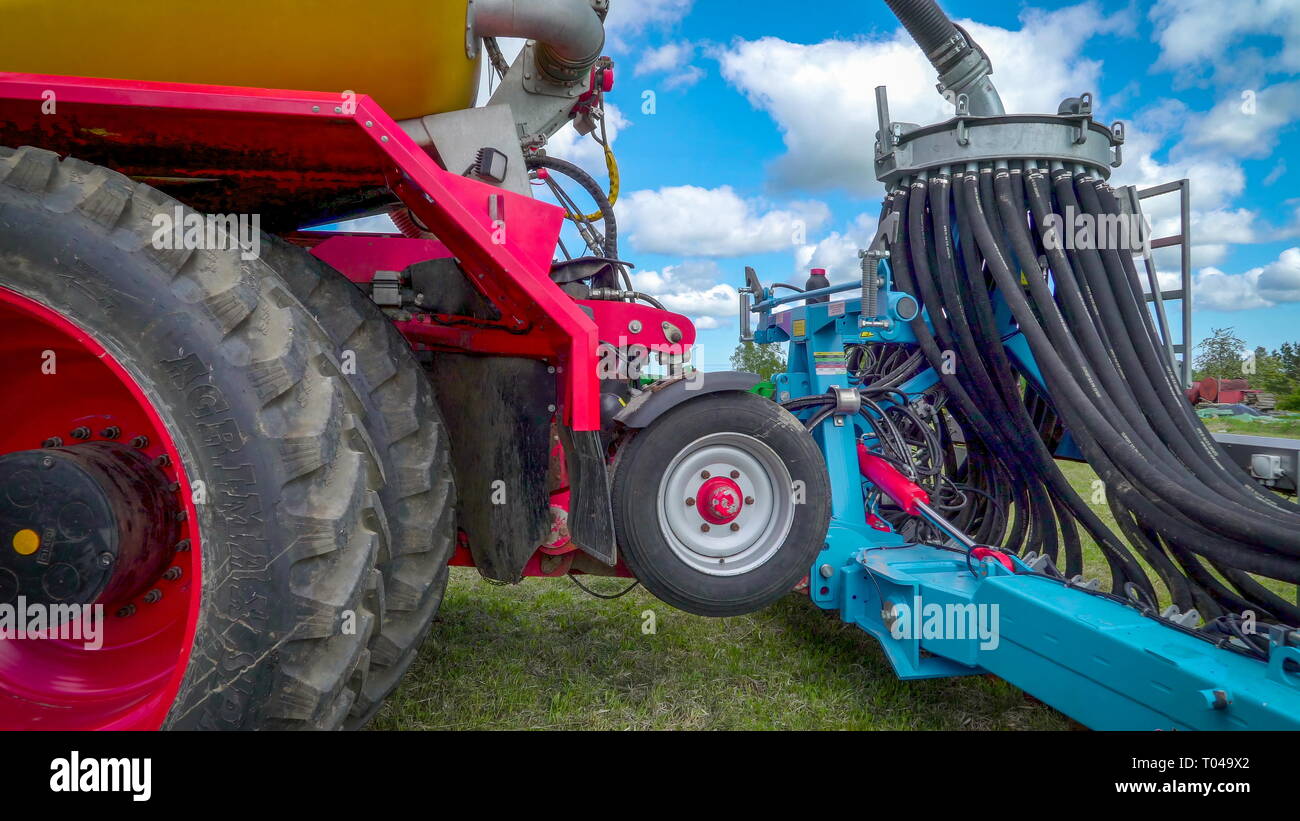 A red heavy equipment tool being displayed outside with the black hose ...