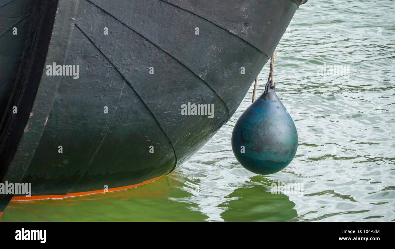 The bouy floating on the side of the boat docking on the canal port ...