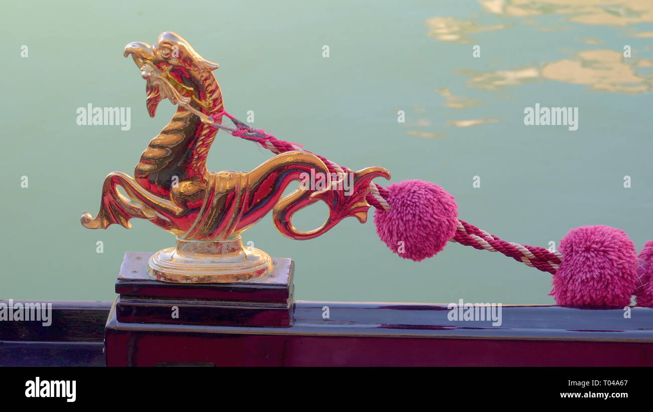 Golden dragon sculpture on the side of the Venetian gondola with the ...