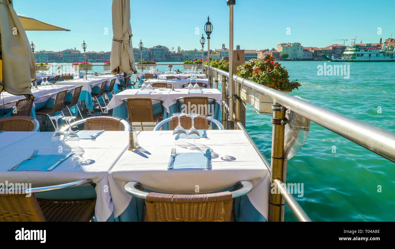 A view of the floating restaurant on the port in Venice with lots of ...