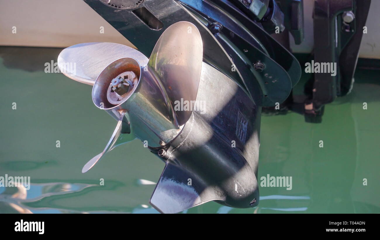 The sharp propeller of the white speedboat while docking on the canal ...