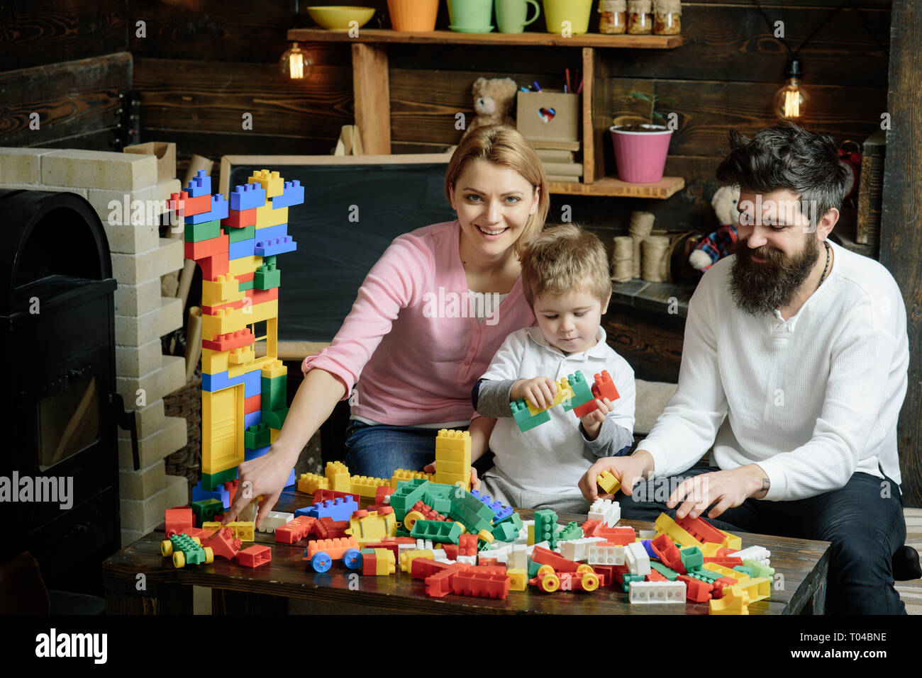 Enjoy concept. Little child and family enjoy playing with toy bricks ...