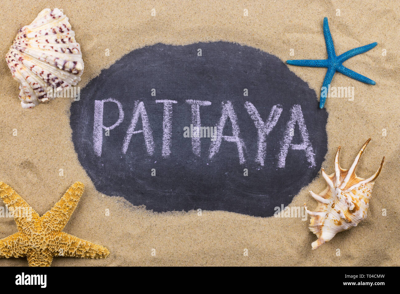 Handwritten word PATTAYA written in chalk, among seashells and ...