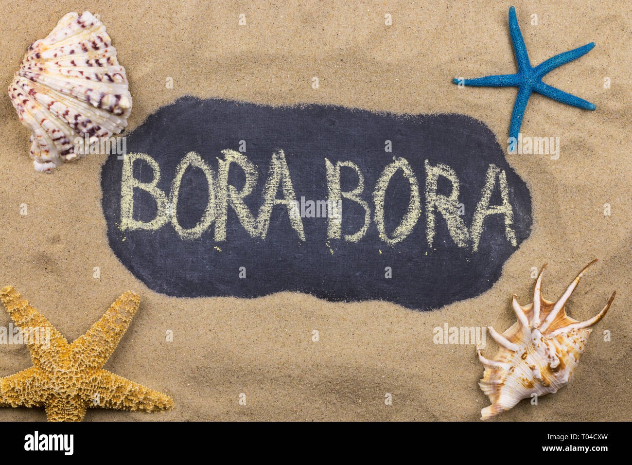 Handwritten word BORA BORA written in chalk, among seashells and ...