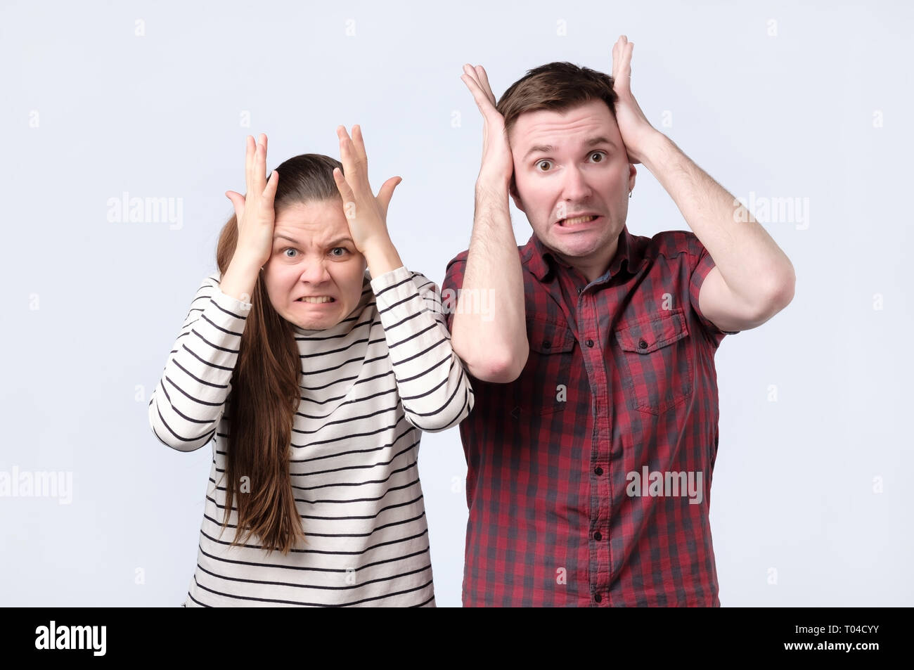 Couple in awe stare with stressed facial expression, have fearful look ...