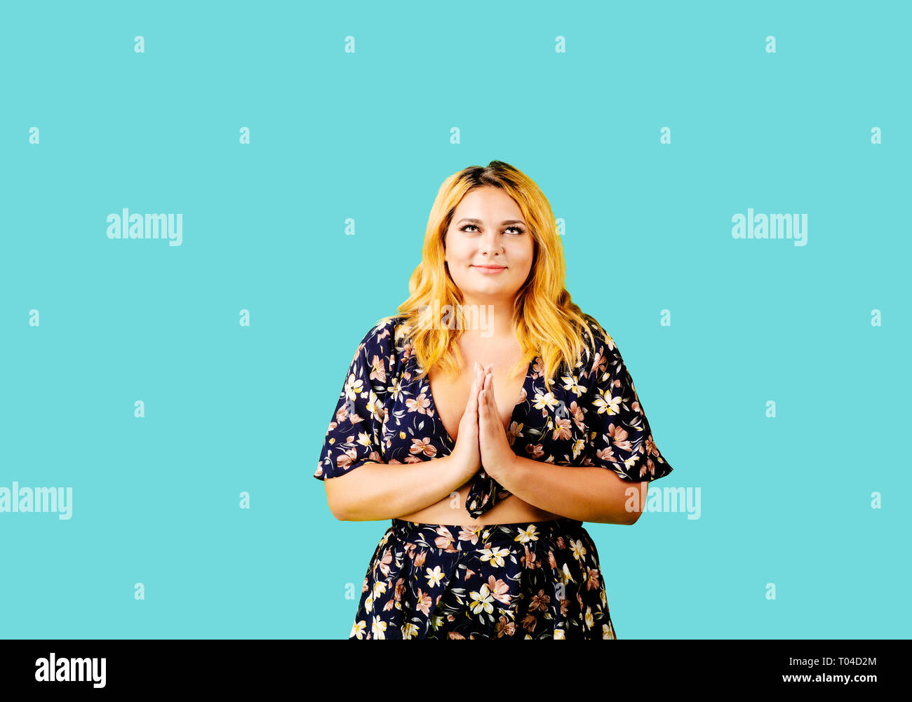 Portrait of a young woman with both hands together in prayer Stock ...