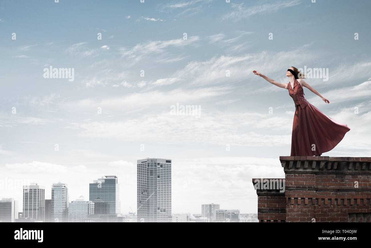 Blind woman in long red dress at top of building. Mixed media Stock ...
