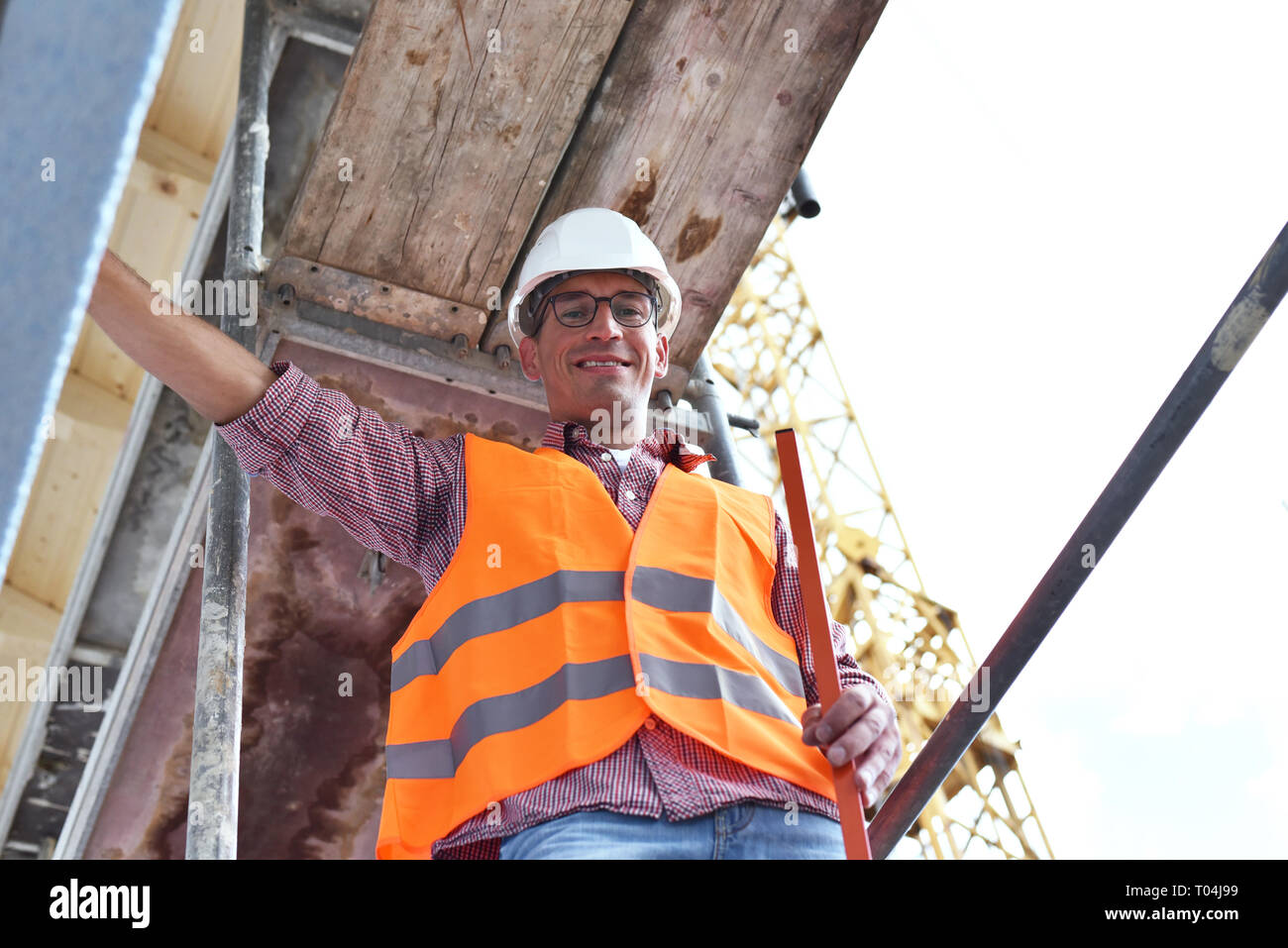 portrait smiling construction manager / architect on site during the ...