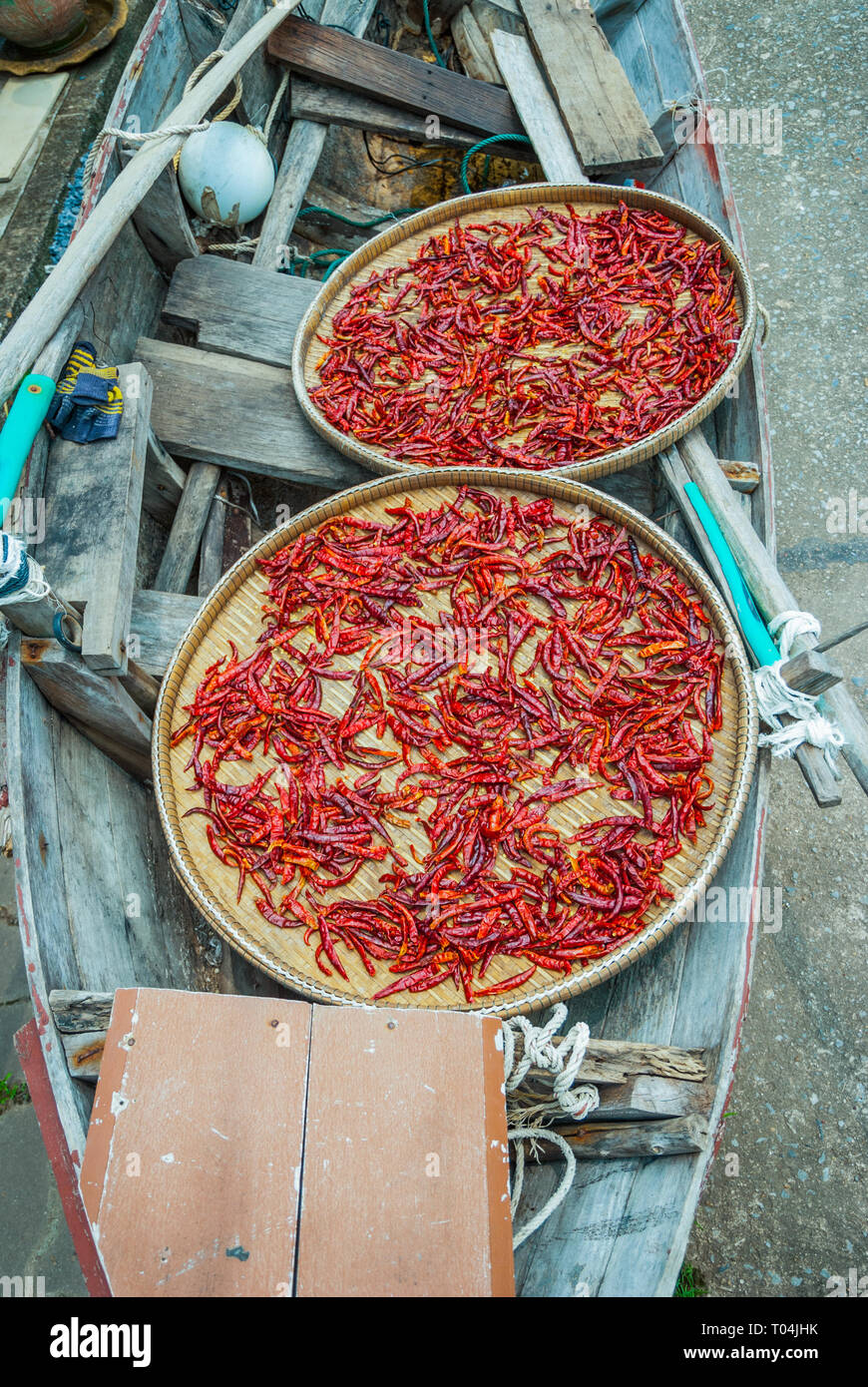 Hot red thai chillies drying outside in a boat Stock Photo - Alamy