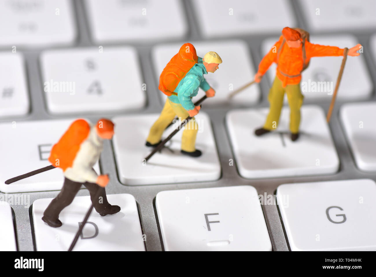 Hikers walking across a computer keyboard Stock Photo - Alamy