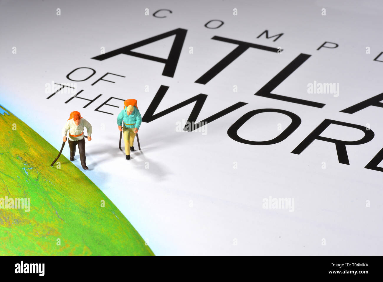 Miniature figures walking around the world Stock Photo - Alamy