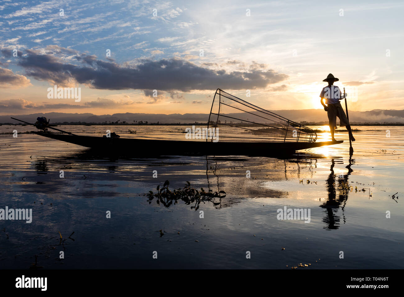 Fishermen fishing with big net in traditional and unique one-leg rowing ...
