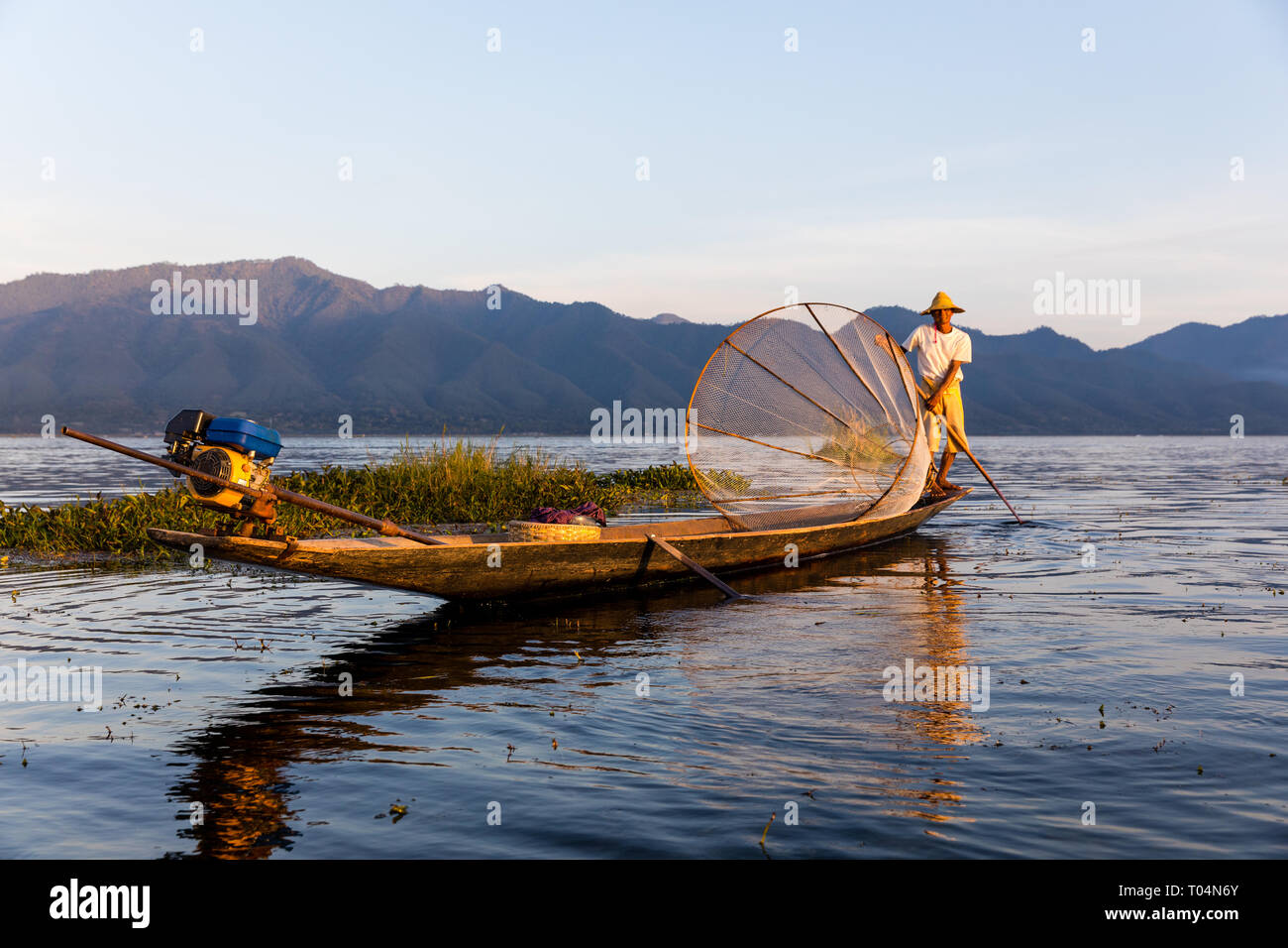 Fishermen fishing with big net in traditional and unique one-leg rowing ...