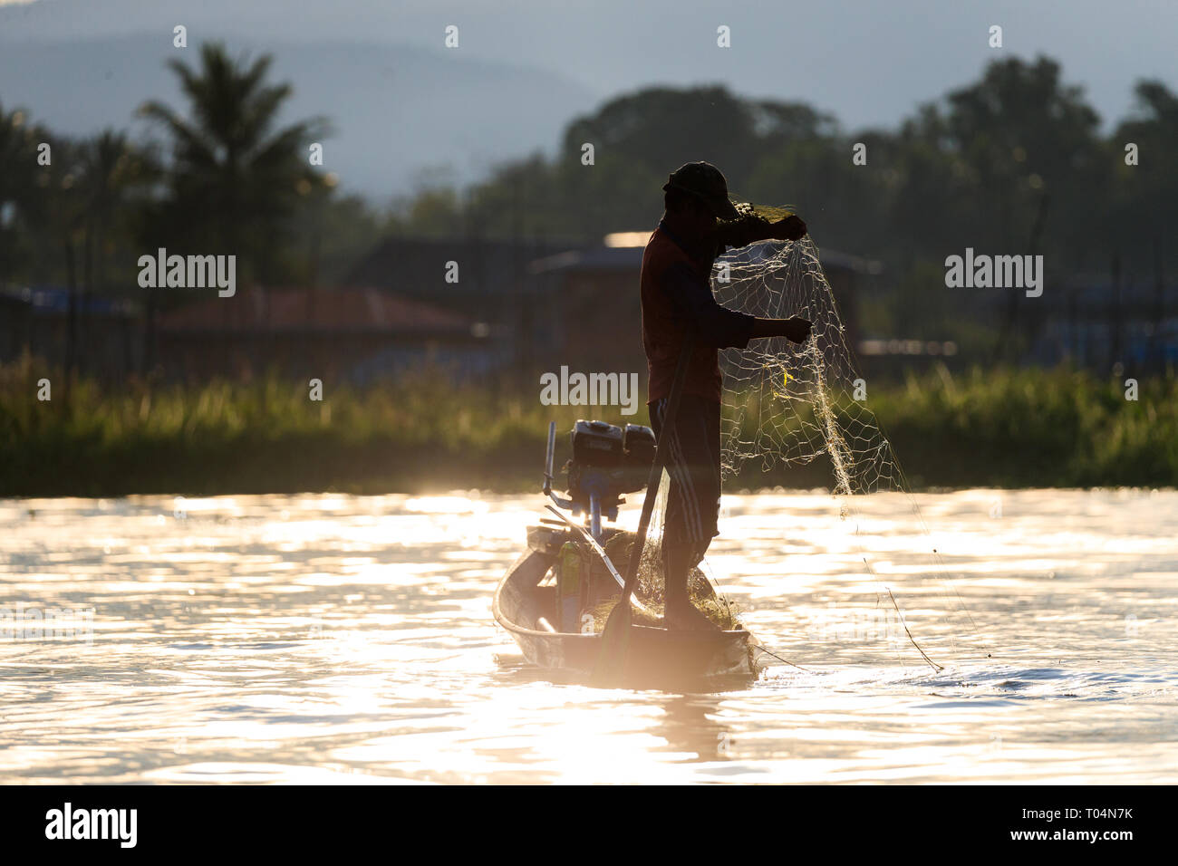 Fishermen fishing with big net in traditional and unique one-leg rowing ...