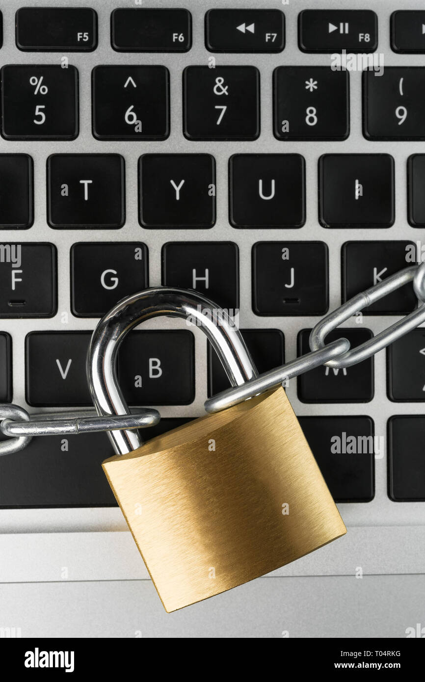 Padlock with chain on a laptop computer keyboard. Cyber security ...