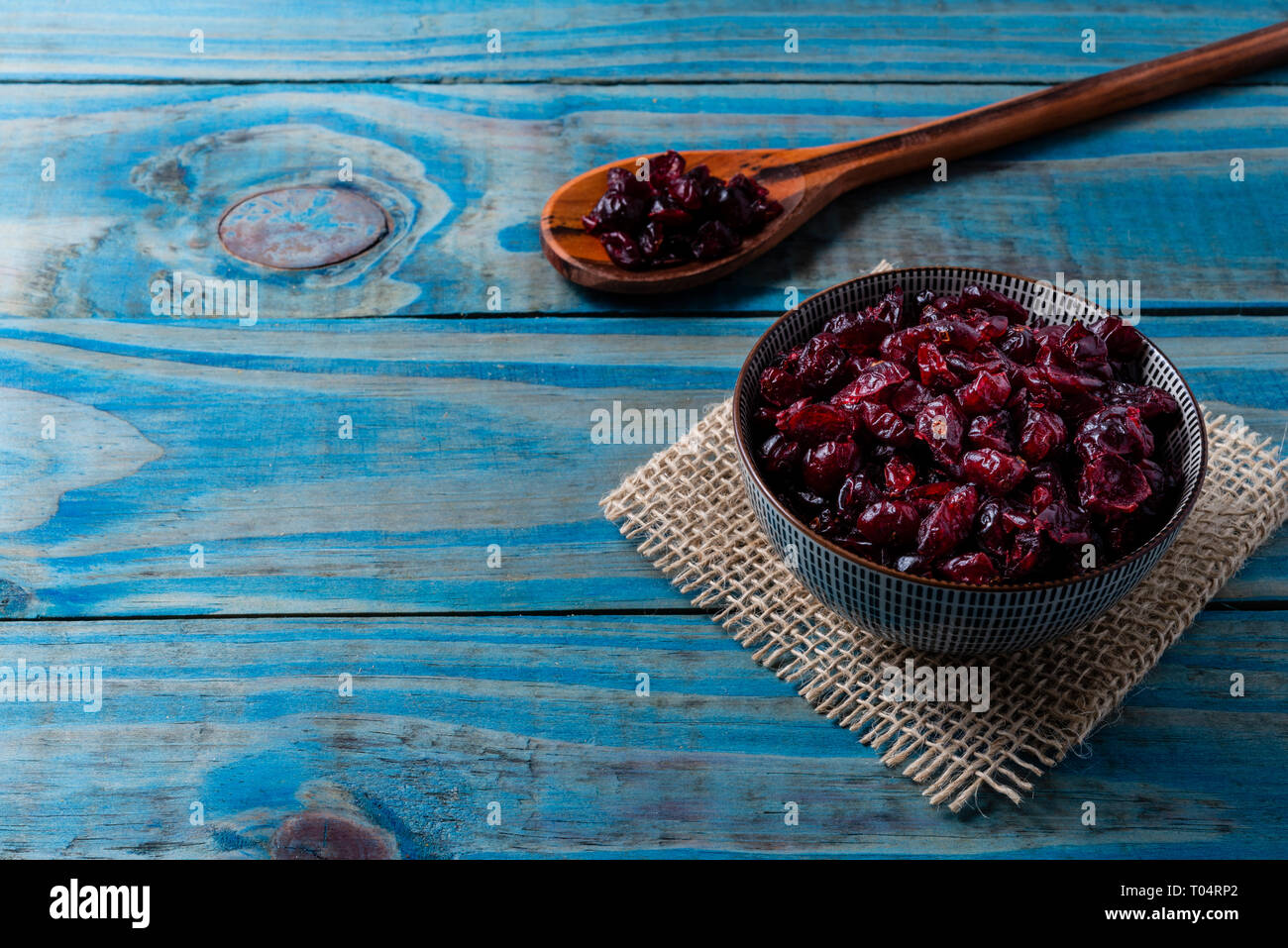 Cranberry dry pot inside ceramic pot on blue pine wood Stock Photo - Alamy