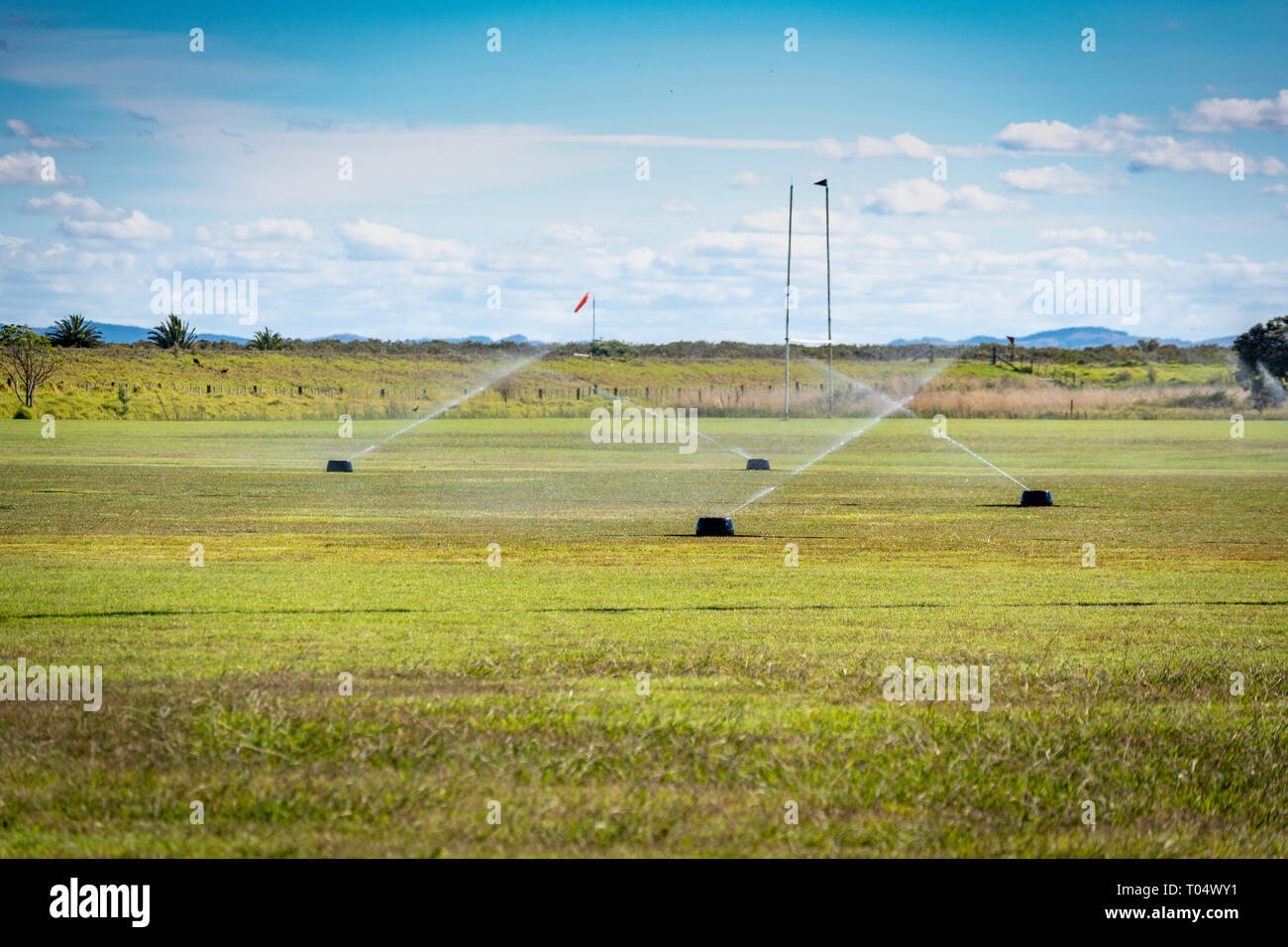 A rugby and soccer fields being watered after the game Stock Photo - Alamy