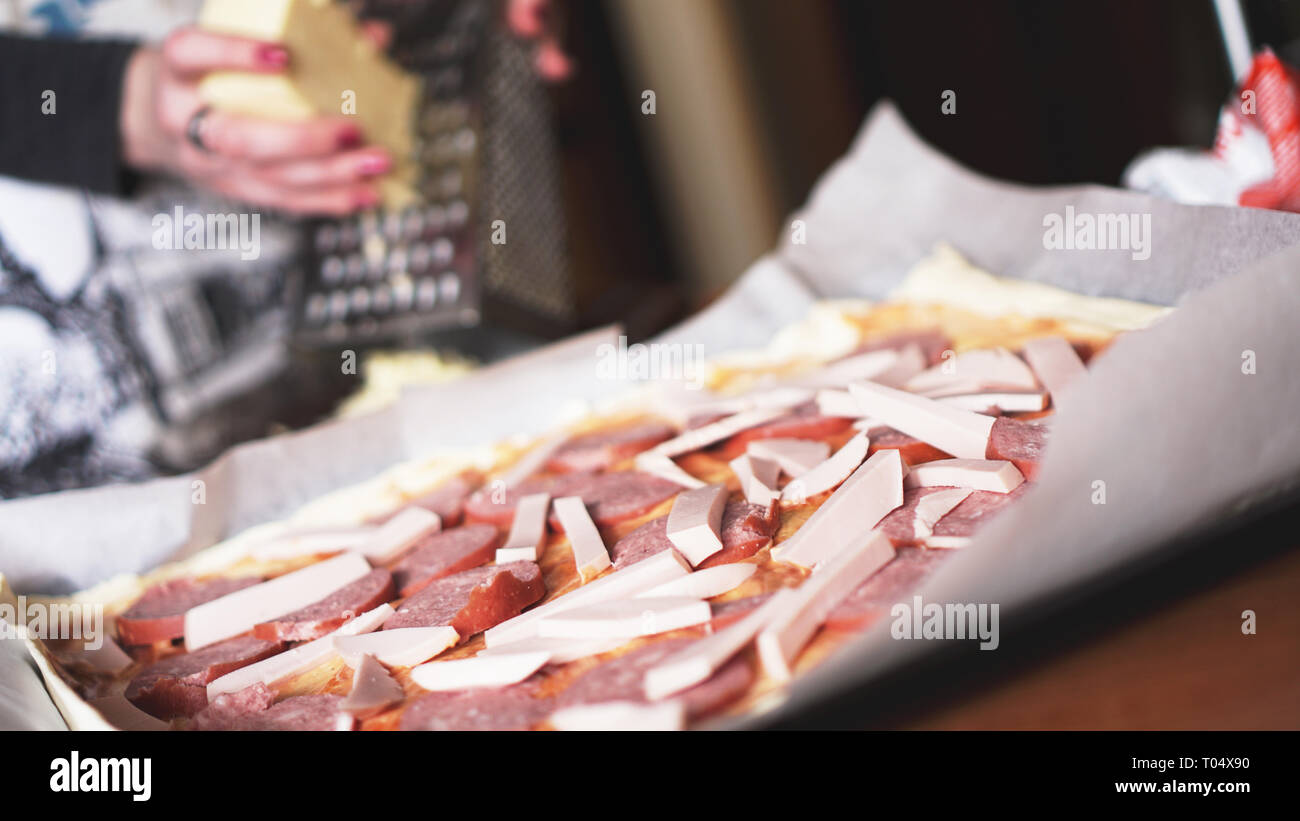 Closeup hand of chef baker making homemade pizza. Female hands rubbing ...