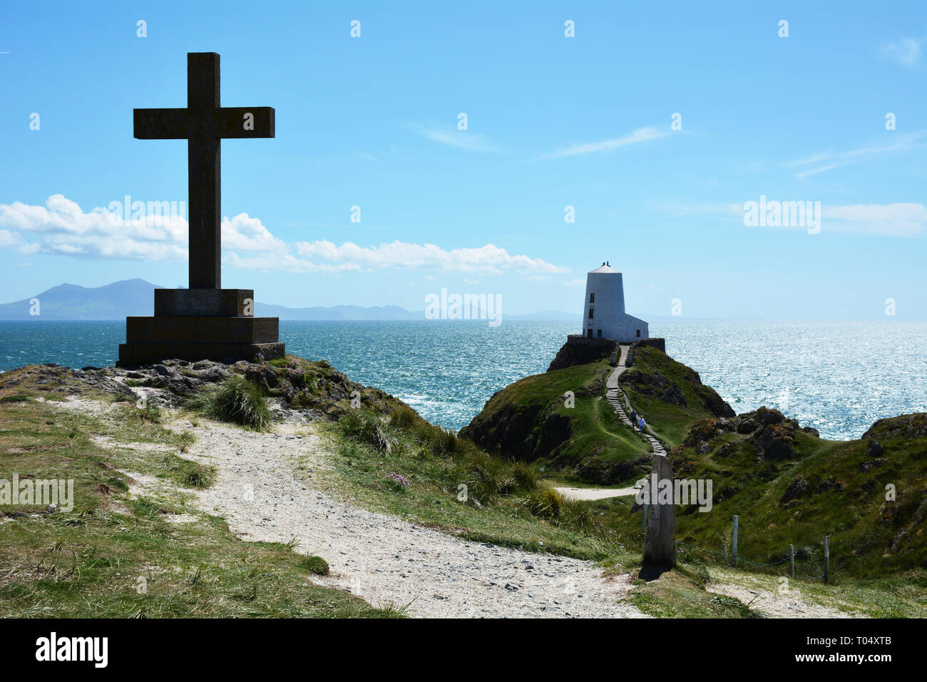 Saint Dwynwen's cross and Twr Mawr lighthouse on Llanddwyn Island. This ...