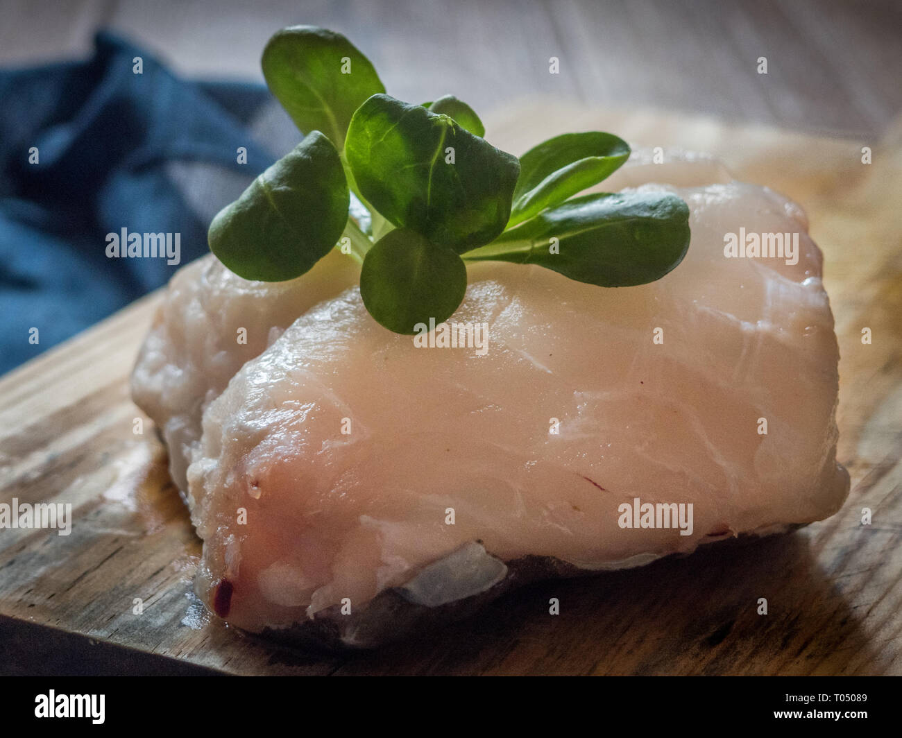 Raw Cod on a table Stock Photo - Alamy