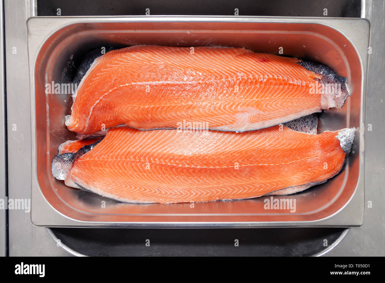 Closeup fresh norwegian salmon fillet fish in metal bowl tray on ...