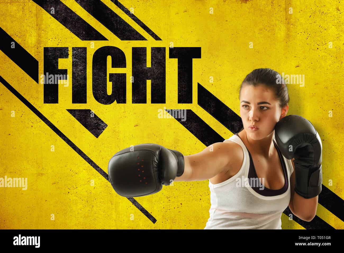 Crop close-up of young woman in boxing gloves holding one hand out ...