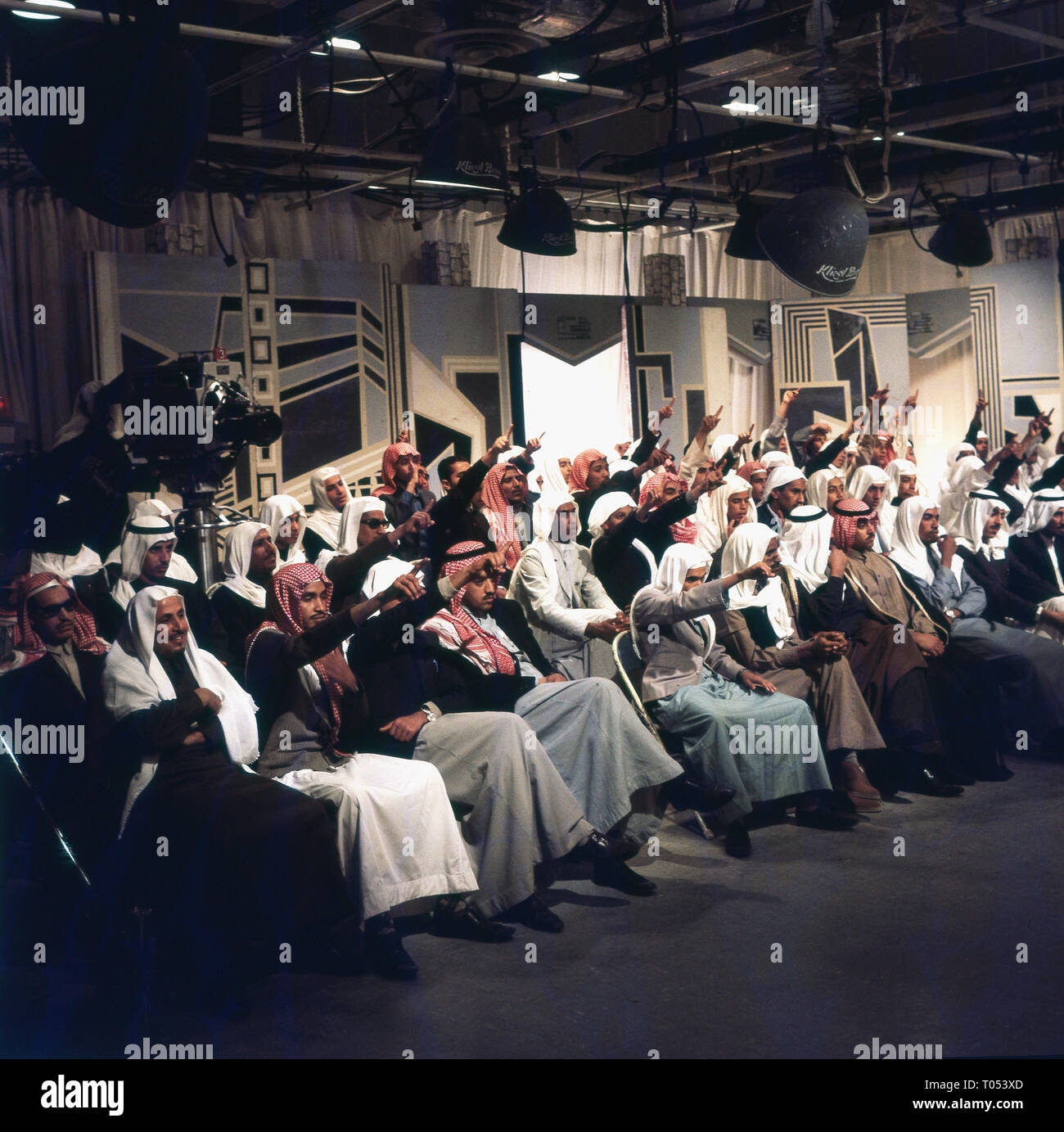 1960s, group of Saudi men in traditional arab dress in a television ...