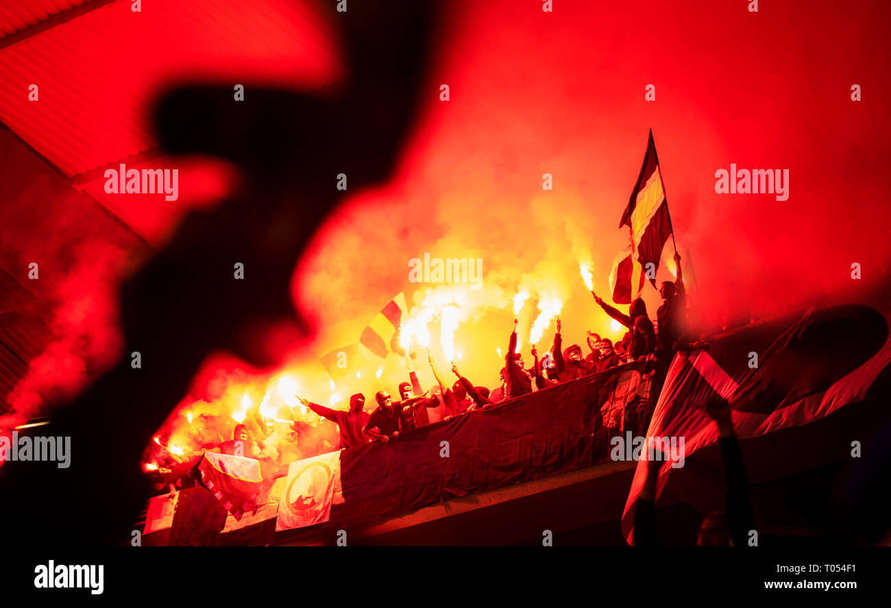 Football Hooligans With Mask Holding Torches In Fire While Supporting