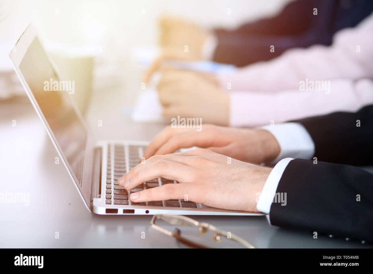 Group of business people working together in office. Man hands typing ...