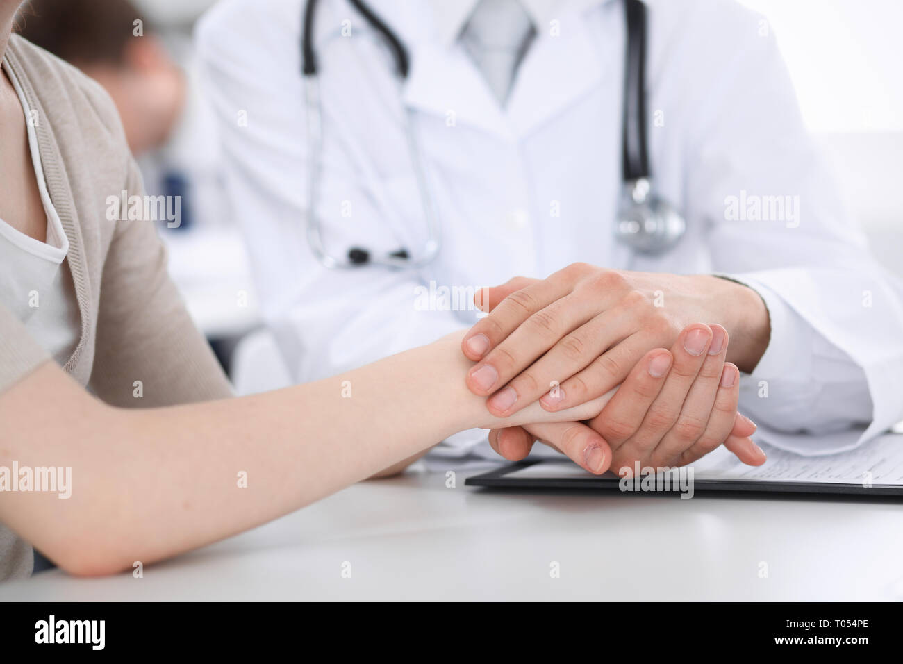 Hand of doctor reassuring her female patient. Medicine and health care ...