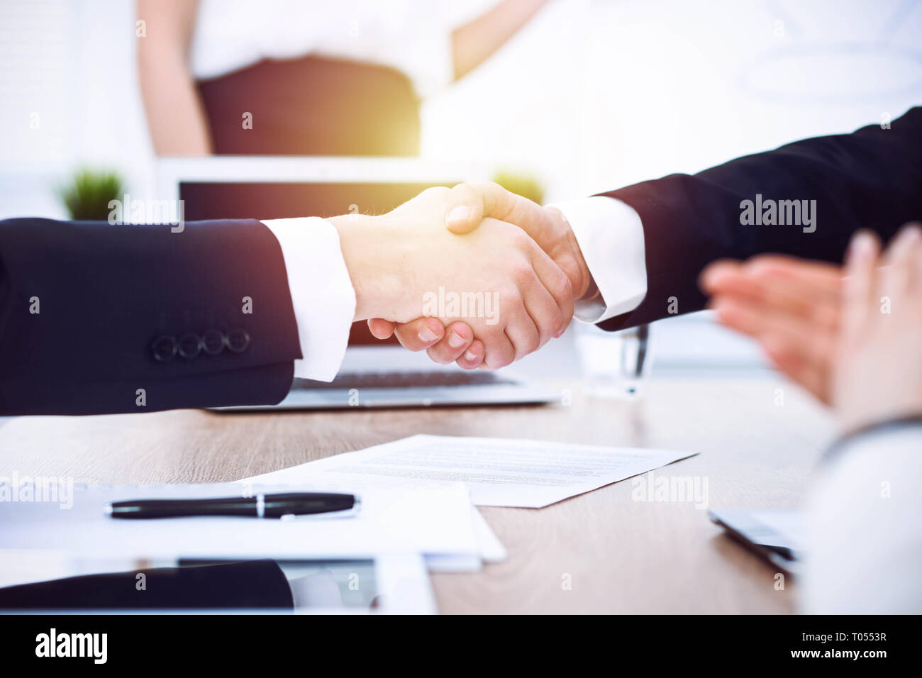 Business people shaking hands at meeting or negotiation in the office ...