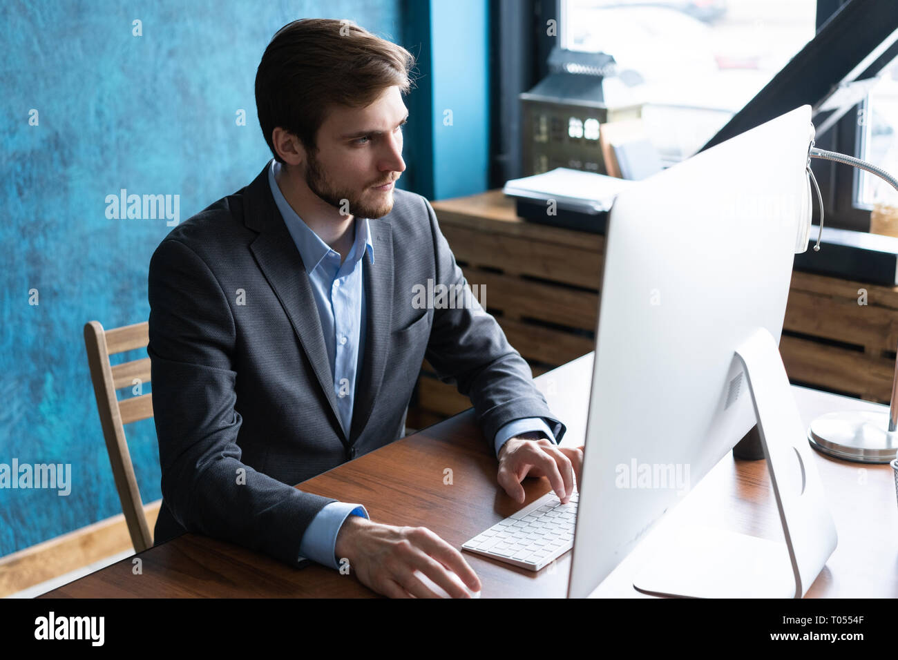 Man Working At Computer In Contemporary Office Stock Photo - Alamy