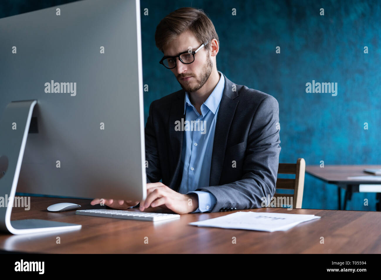 Man Working At Computer In Contemporary Office Stock Photo - Alamy