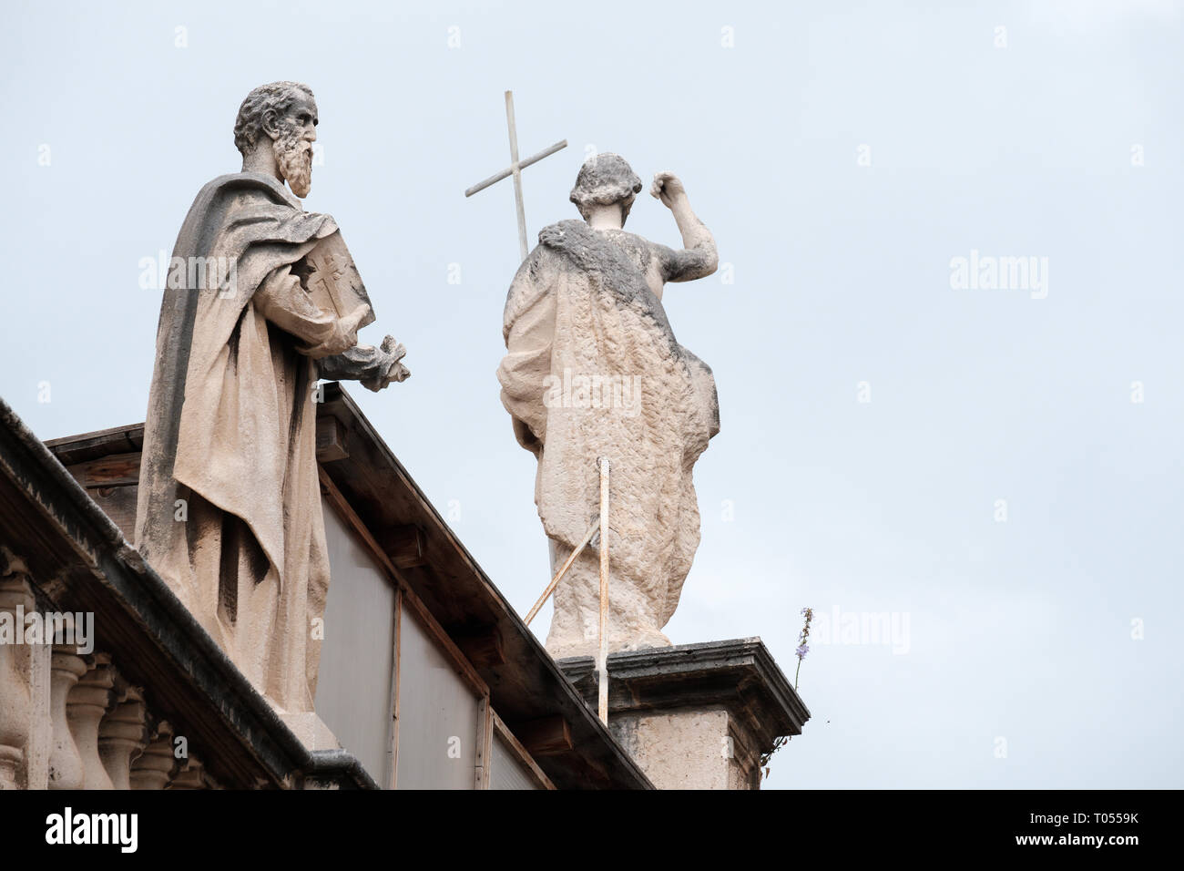 Two ancient statues of holy men on top of one of the buildings in ...