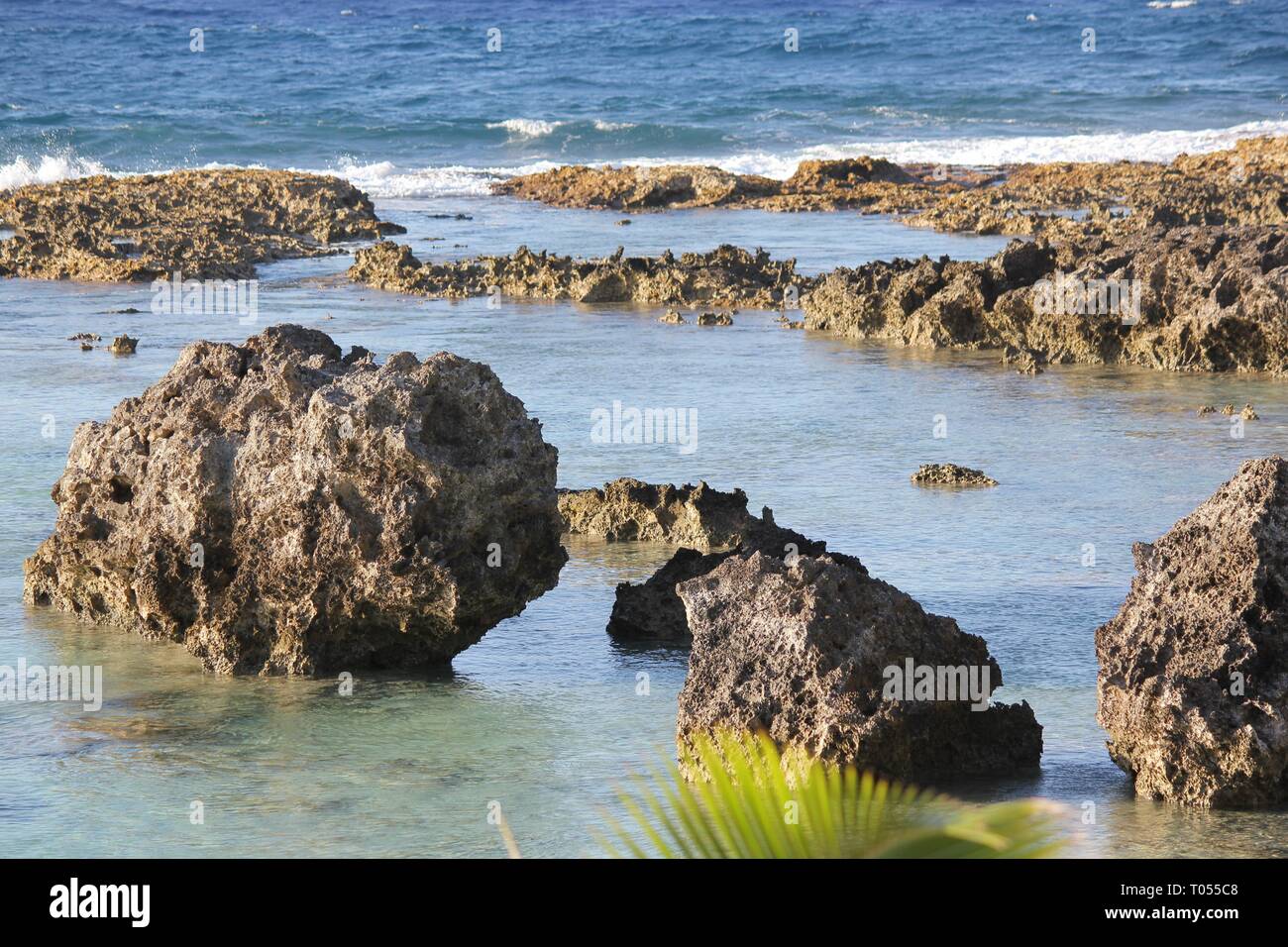 Sharp rocks and corals jutting out of the pristine beaches of Rota ...