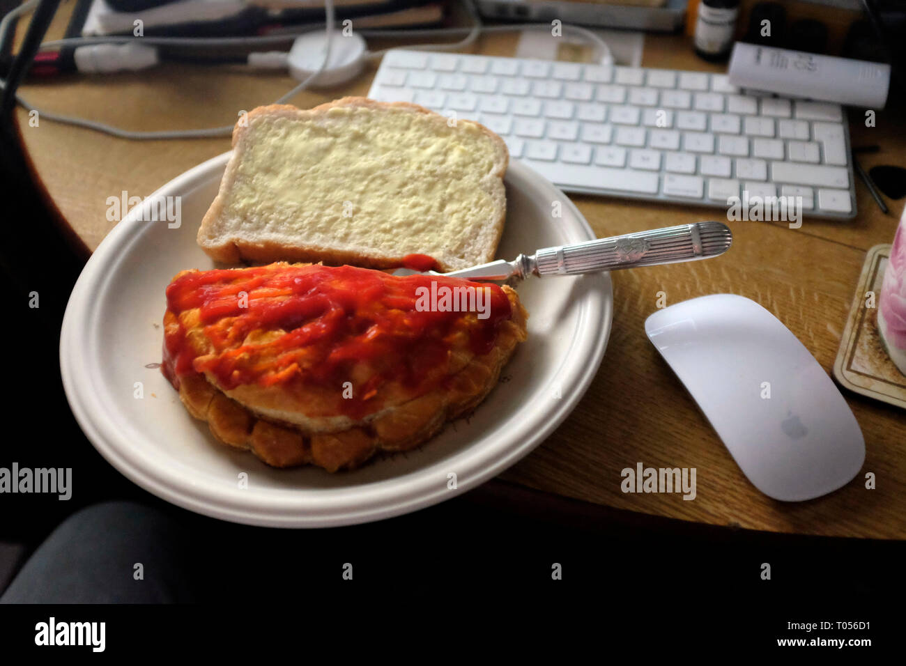 Unhealthy eating at desk hi-res stock photography and images - Alamy
