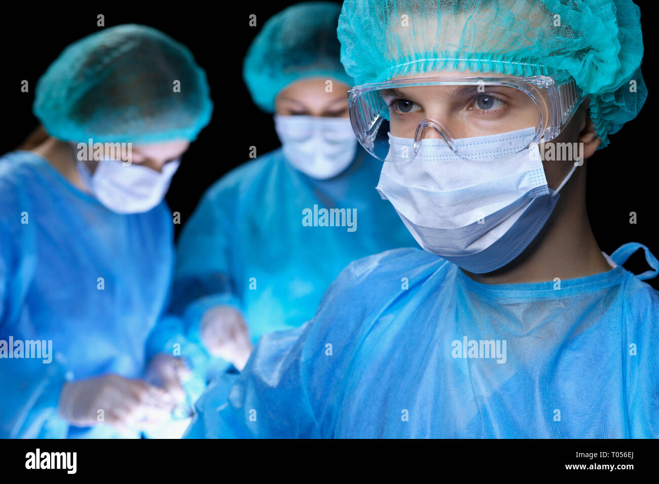 Group of surgeons in masks performing operation. Medicine, surgery and ...