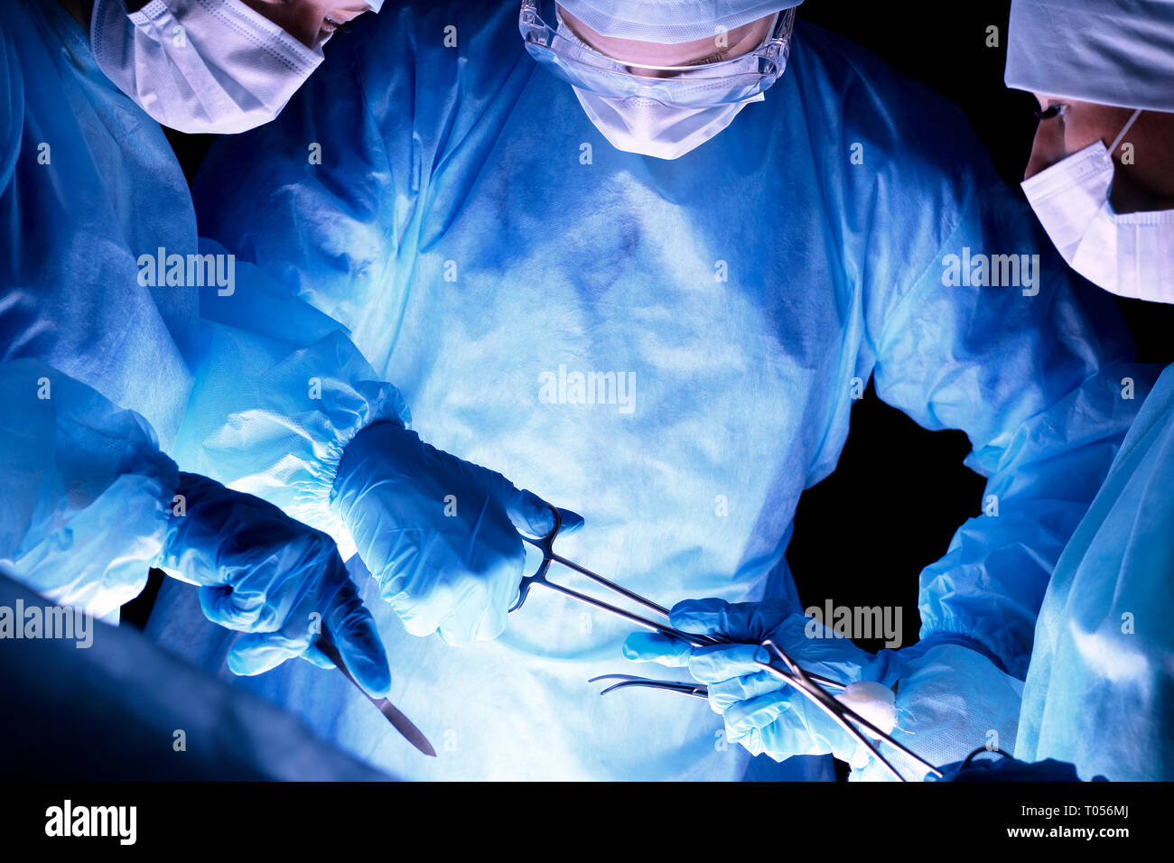 Group of surgeons in masks performing operation. Medicine, surgery and ...