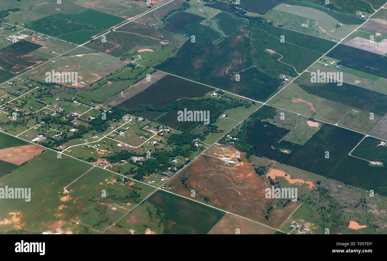 Wide aerial view of green sprawling farmlands en route to Dallas seen ...