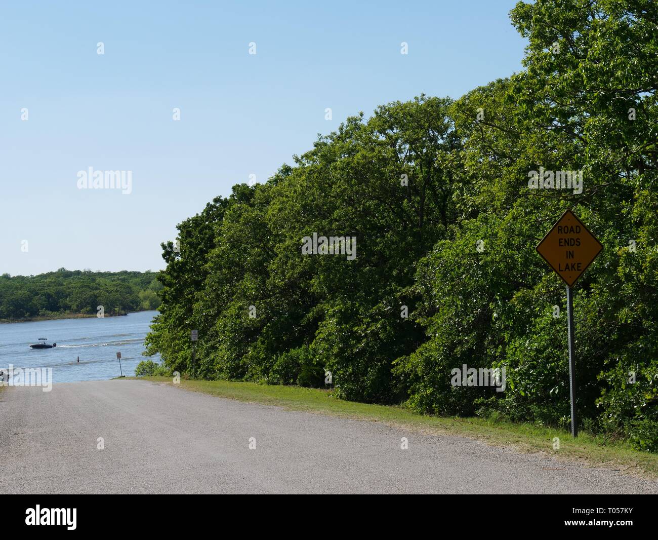 Paved road that ends at the lake, with a roadside sign Stock Photo - Alamy