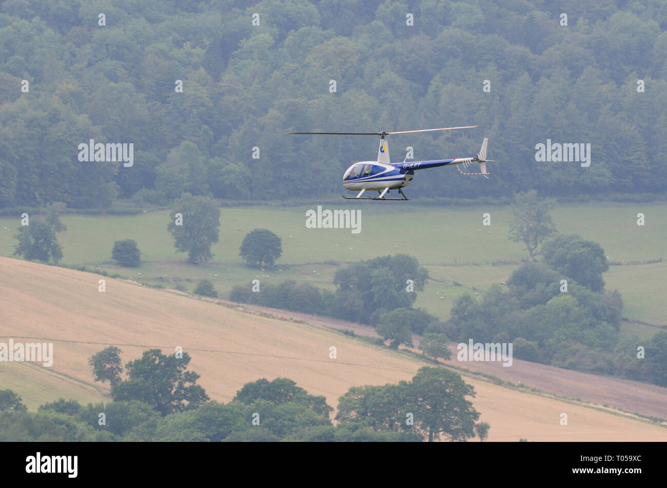 Helicopter in flight above British landscape Stock Photo - Alamy