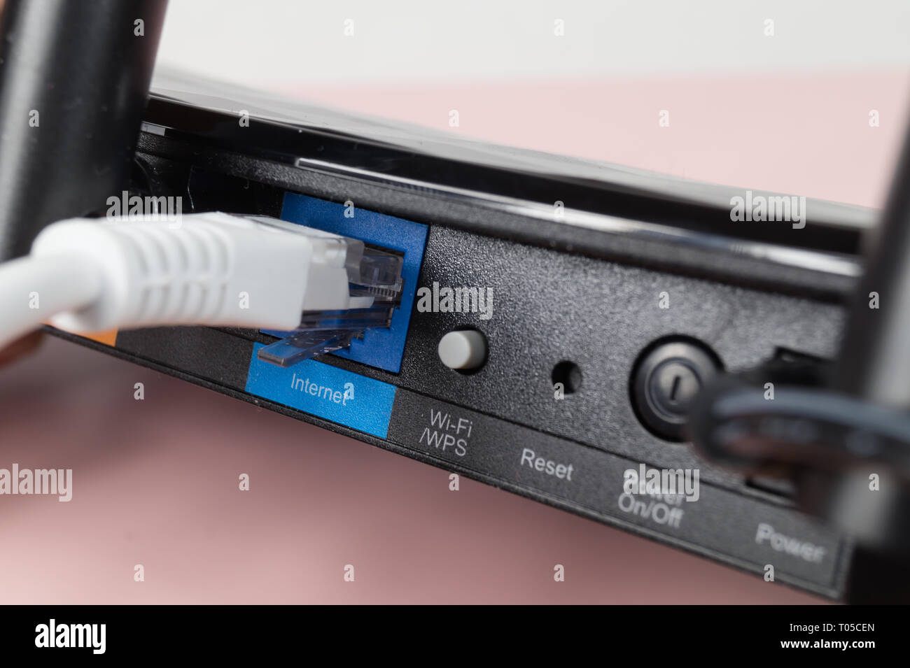 Close up of a modern wlan router with connected internet cable on white ...