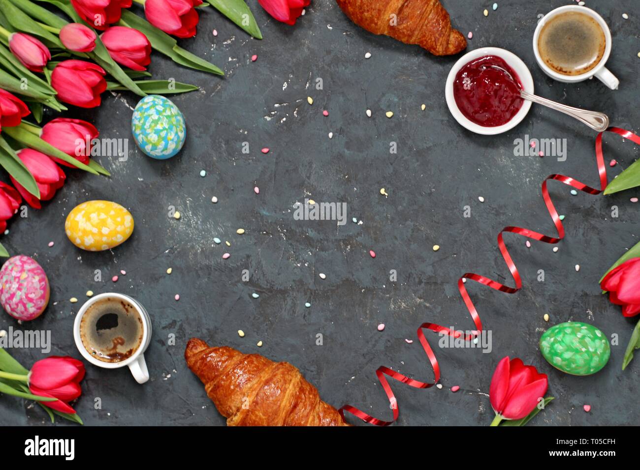 Easter background. Tulips with coffee, colorful eggs and croissant. Top ...